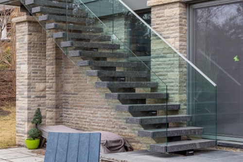 exterior stone steps staircase with glass railing